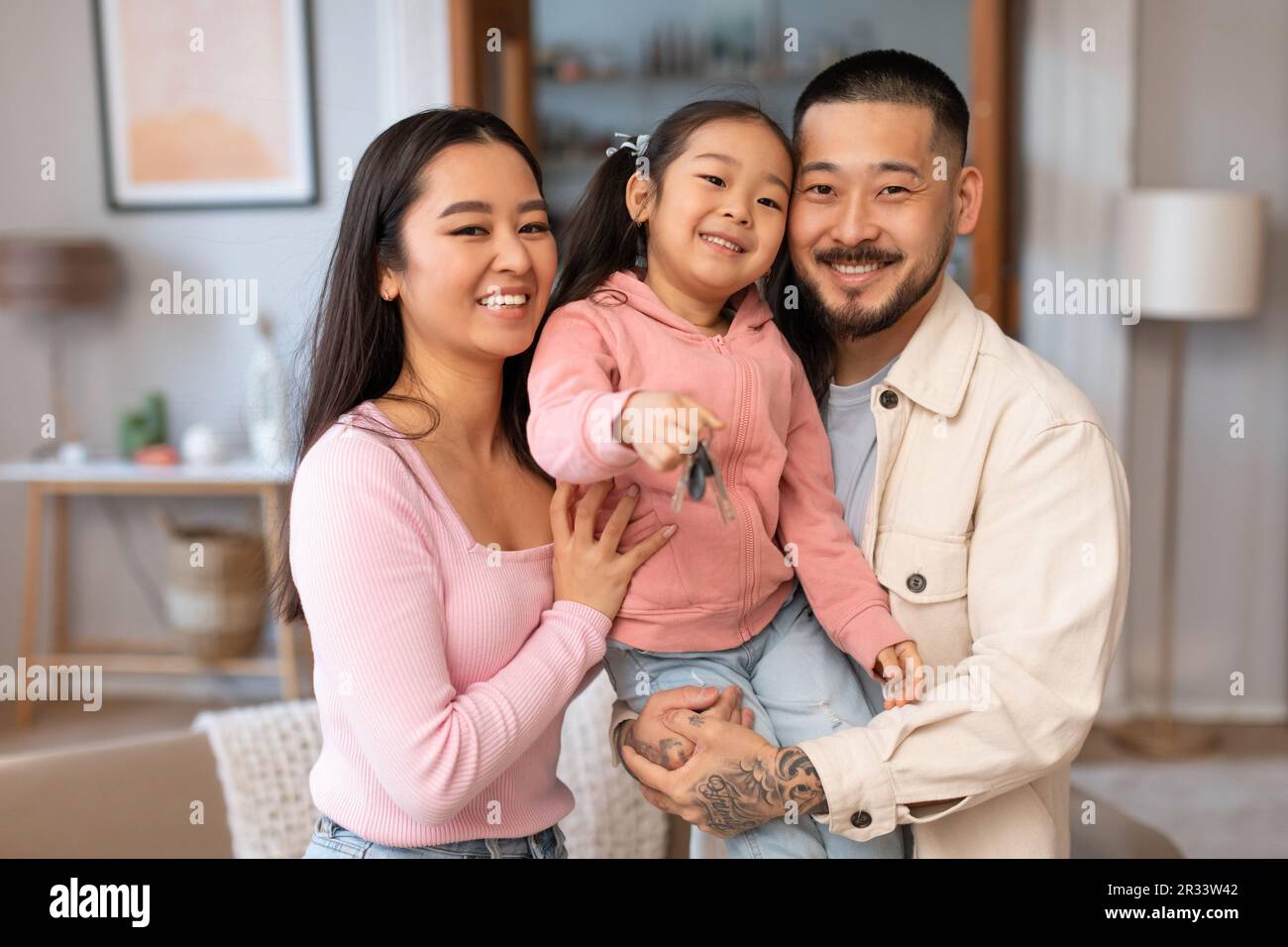 Korean Parents And Little Daughter Showing New House Keys Indoor Stock ...