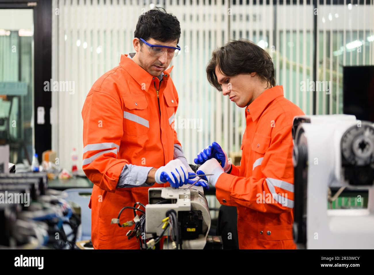 Engineers working and solving problems on machine at industrial plant Stock Photo - Alamy