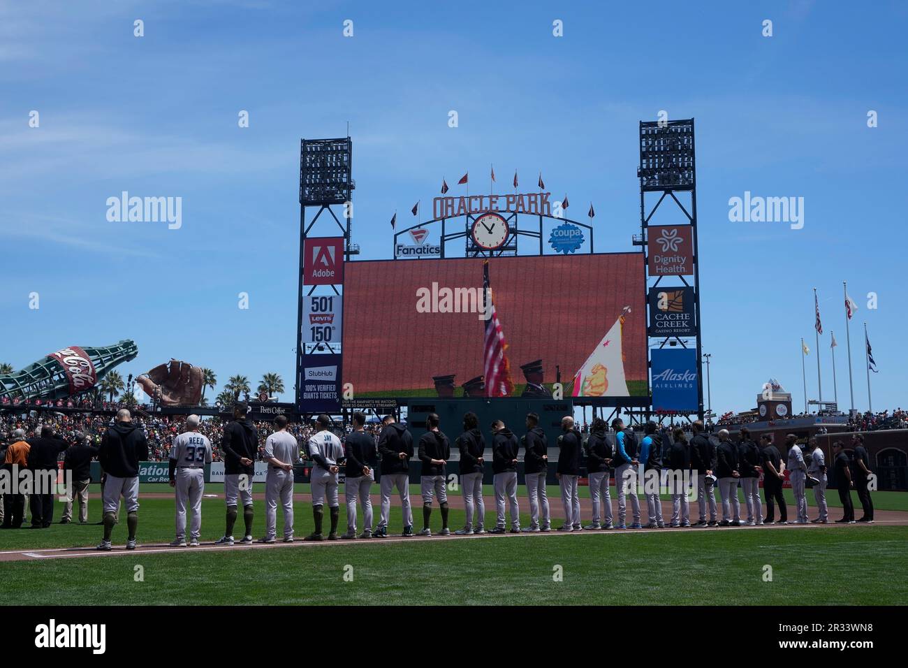Players and staff stand during the national anthem on Salute to the ...