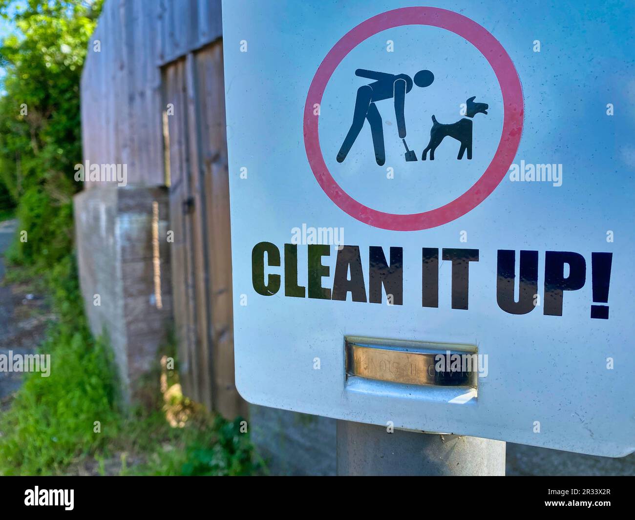 Clean it up dog poo sign Stock Photo - Alamy