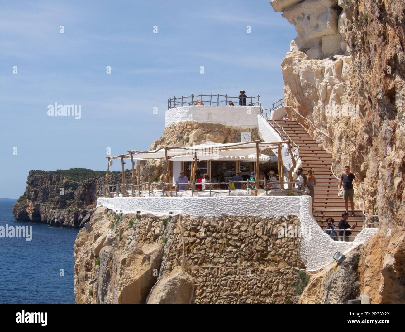 Steep cliff-side path down to Bar Cova D’En Xoroi on Menorca island ...