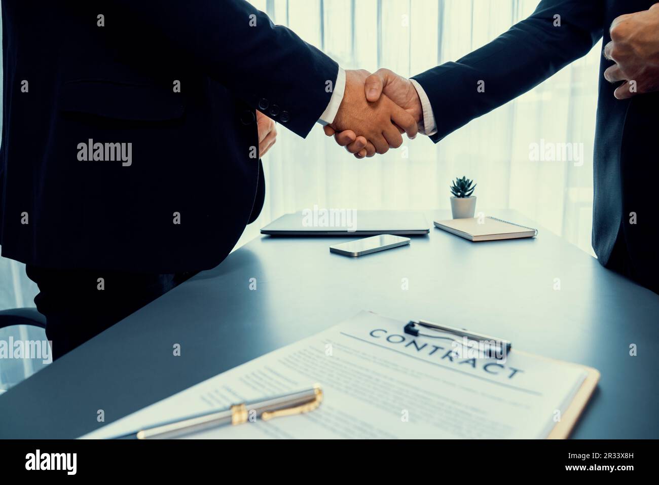 Two professionals successfully close business deal with closeup ...