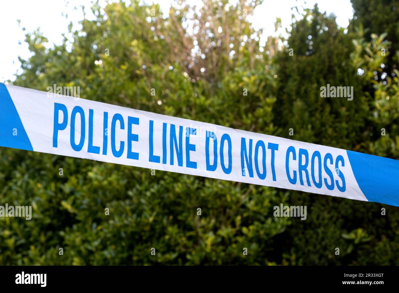 close up of police line do not cross tape at cordon around crime scene ...