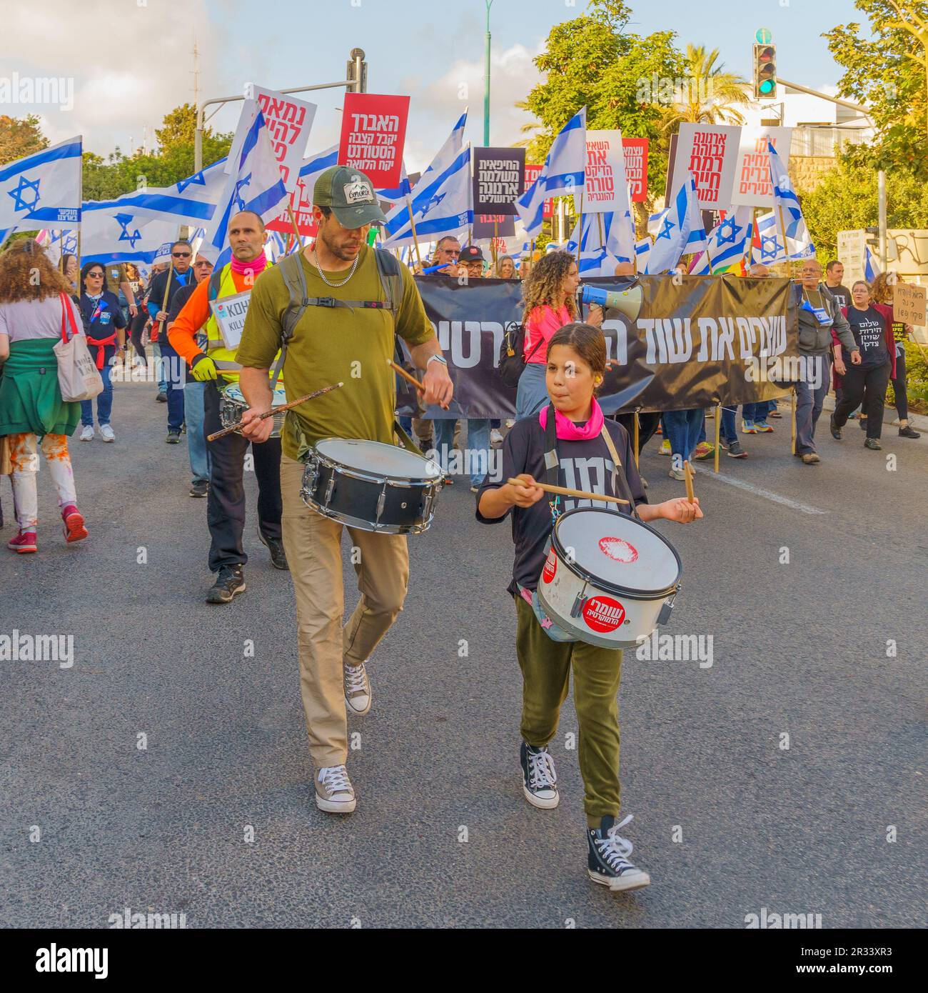 Haifa, Israel - May 20, 2023: People marching with flags and various ...
