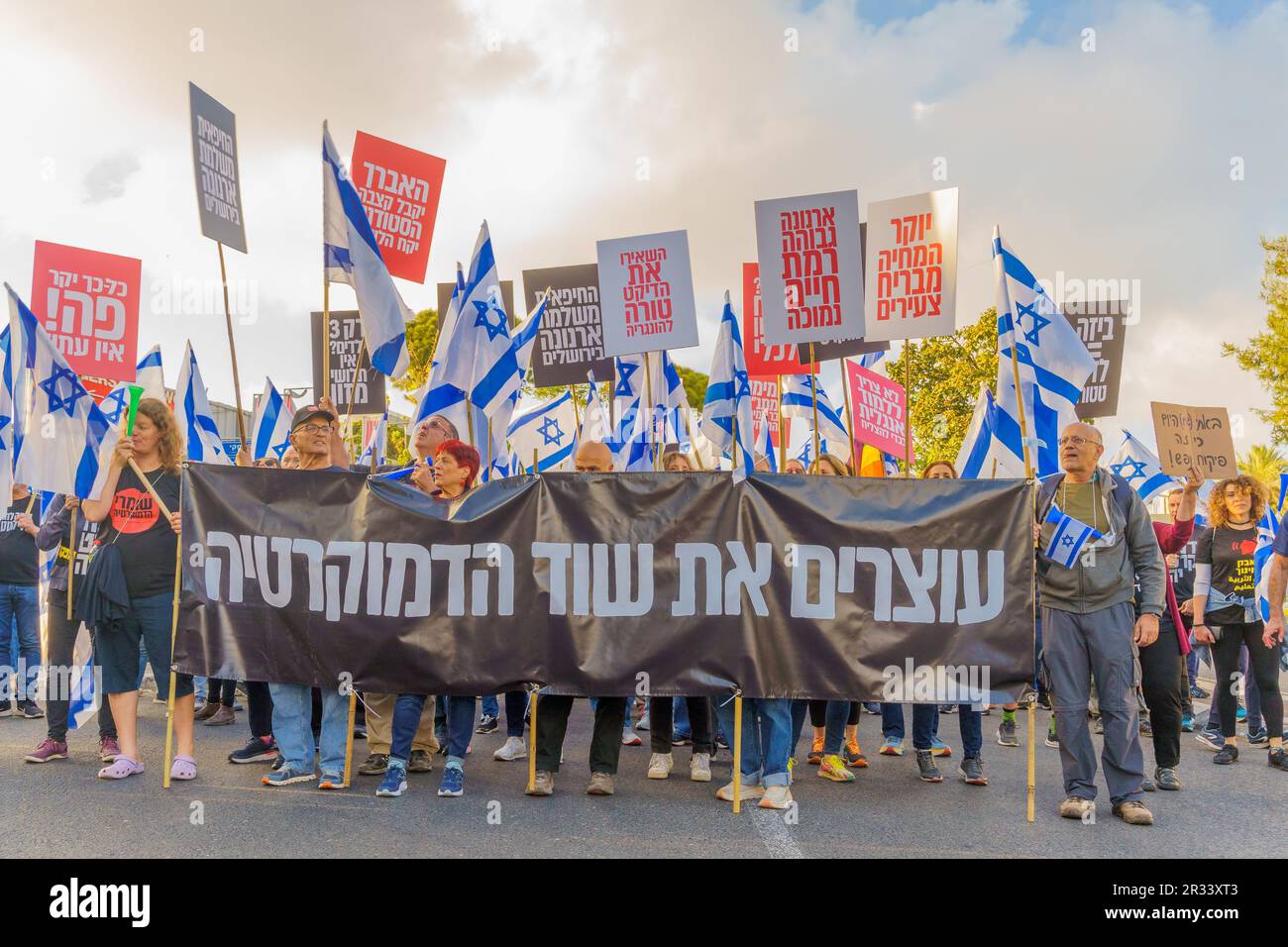 Haifa, Israel - May 20, 2023: People marching with flags and various ...