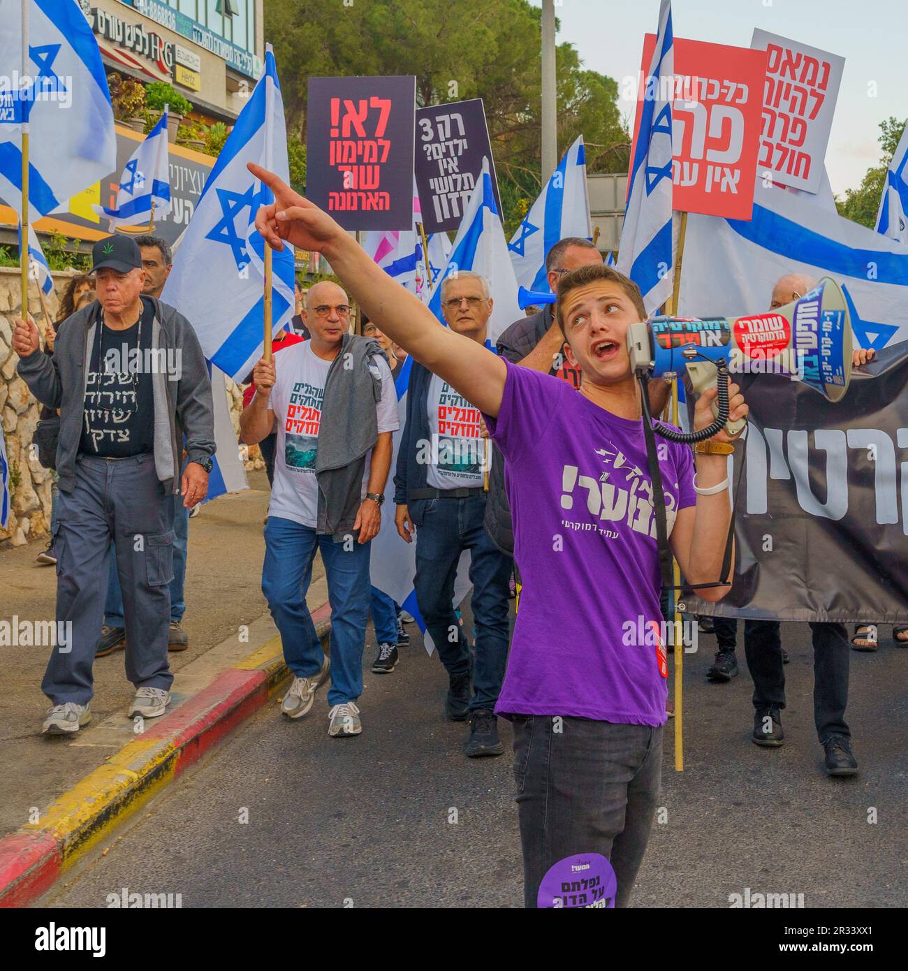 Haifa, Israel - May 20, 2023: People marching with flags and various ...