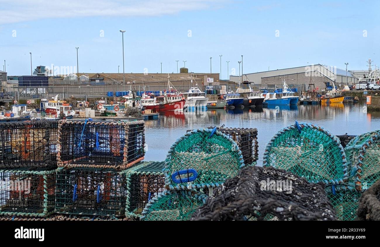 Lobster pots and boats in Peterhead harbour Stock Photo - Alamy