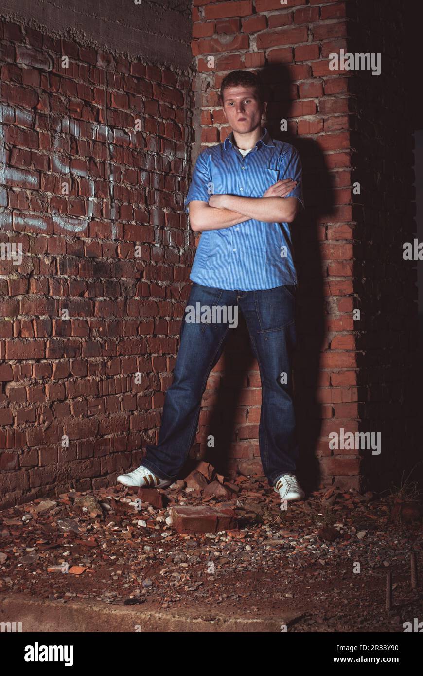 Man leaning on a brick wal Stock Photo - Alamy