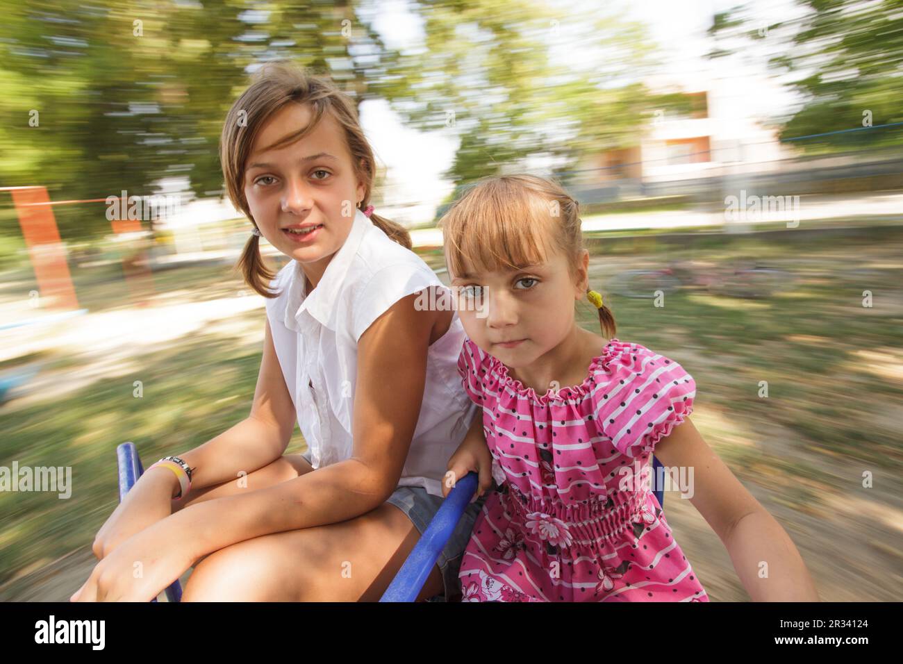 Two sisters on the carousel Stock Photo - Alamy