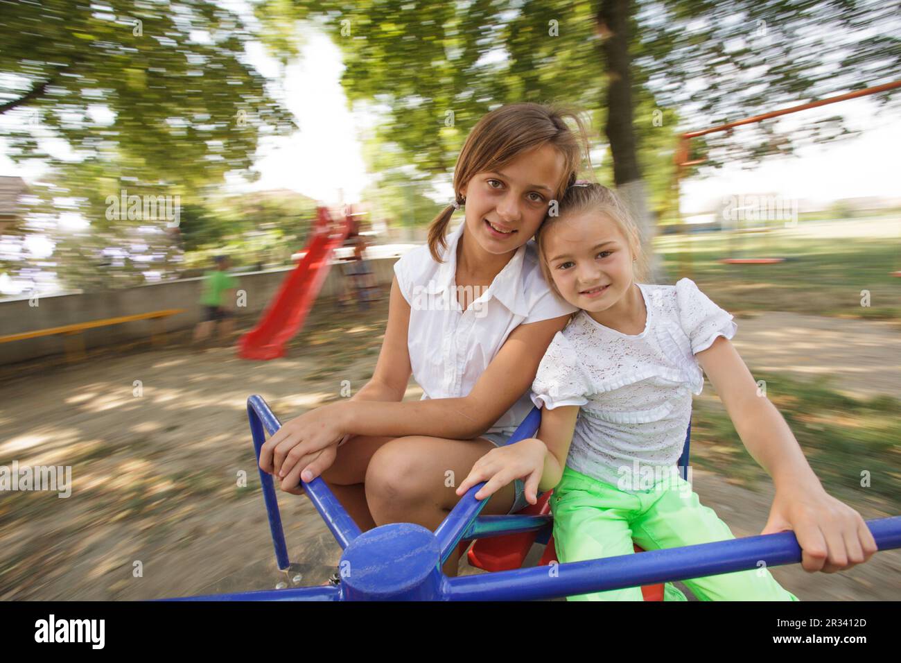 Two girls on the carousel Stock Photo - Alamy