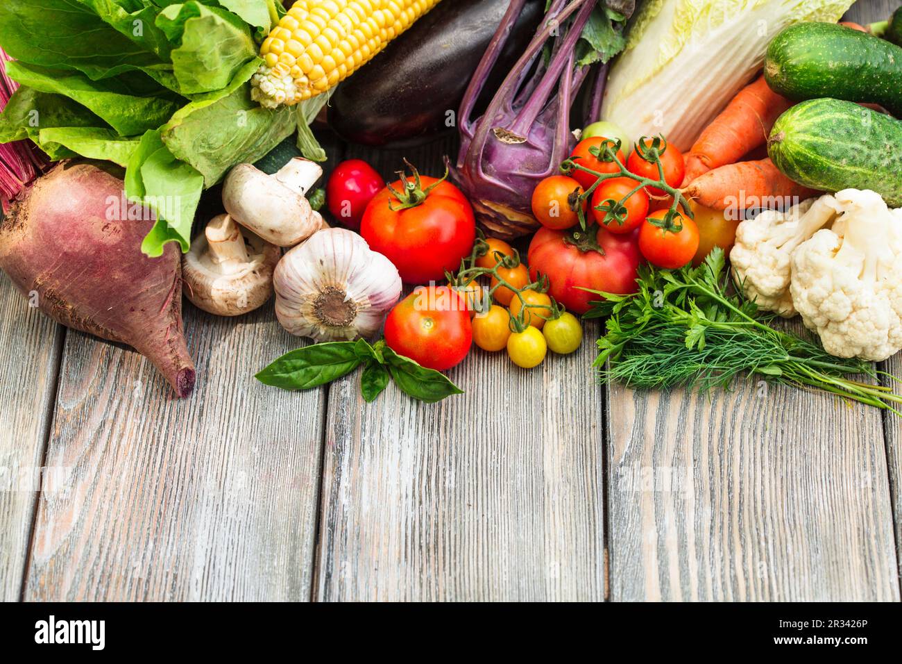 Vegetables on wooden table Stock Photo - Alamy