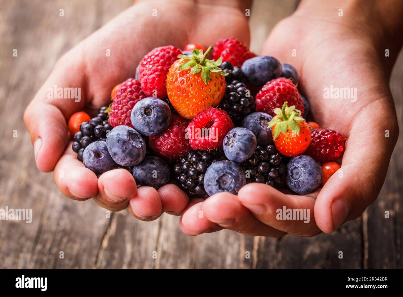 Woman handful strawberry berries hi-res stock photography and images ...