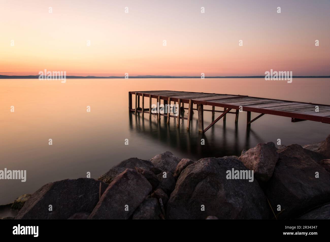jetty at beach with sunset Stock Photo - Alamy