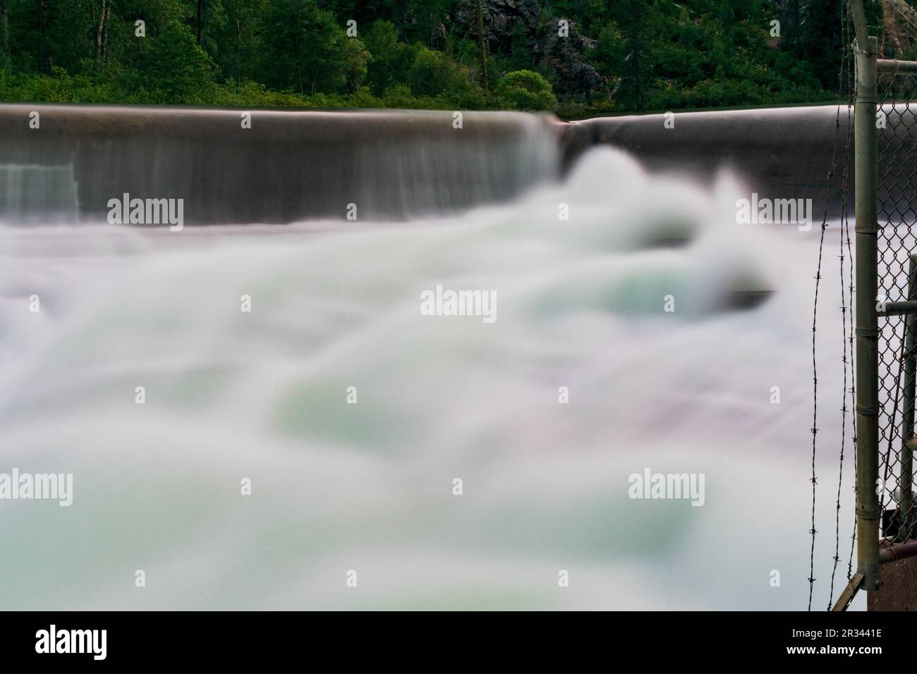 Fast moving water flowing over concrete dam Stock Photo - Alamy