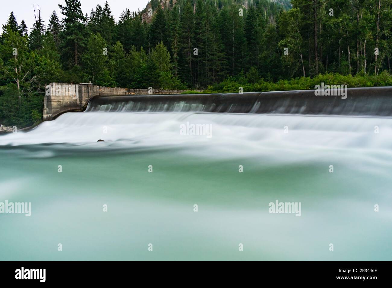 Fast moving water flowing over concrete dam Stock Photo - Alamy