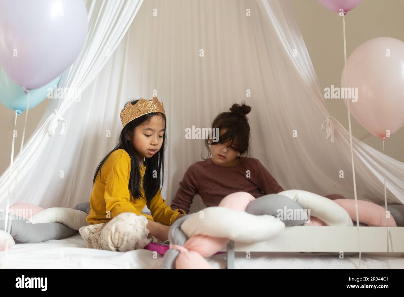 Happy girls playing princess in a play tent Stock Photo - Alamy