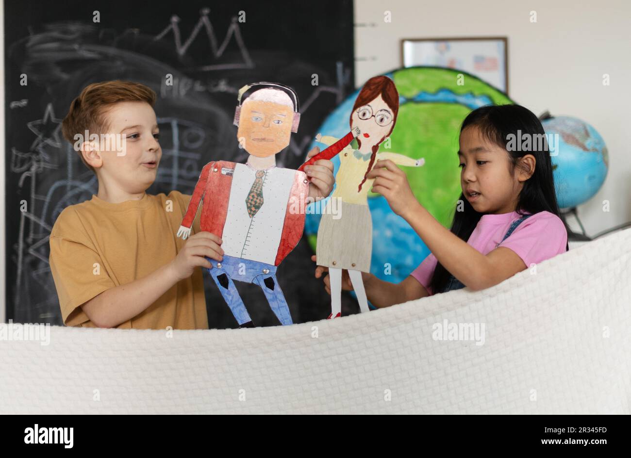 Little children playing with a handmade puppets Stock Photo - Alamy