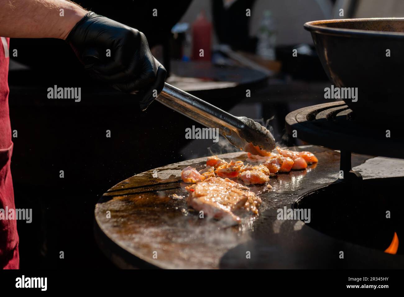 Chef cooking fried chicken meat pieces on brazier - close up Stock ...