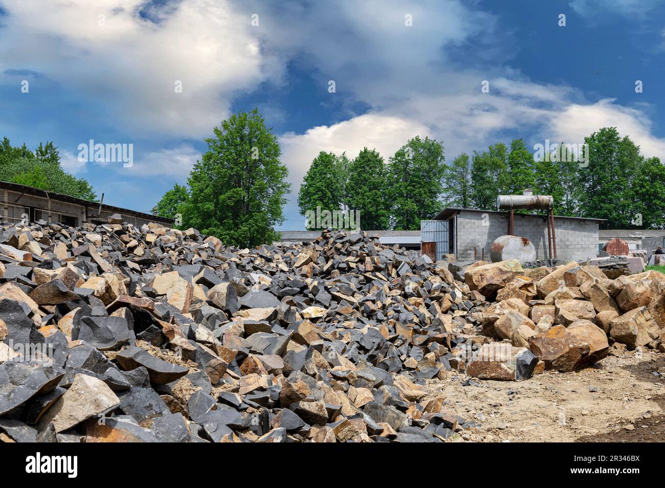 Basalt stones in a quarry. Columnar basalt quarry in summer. Volcanic ...