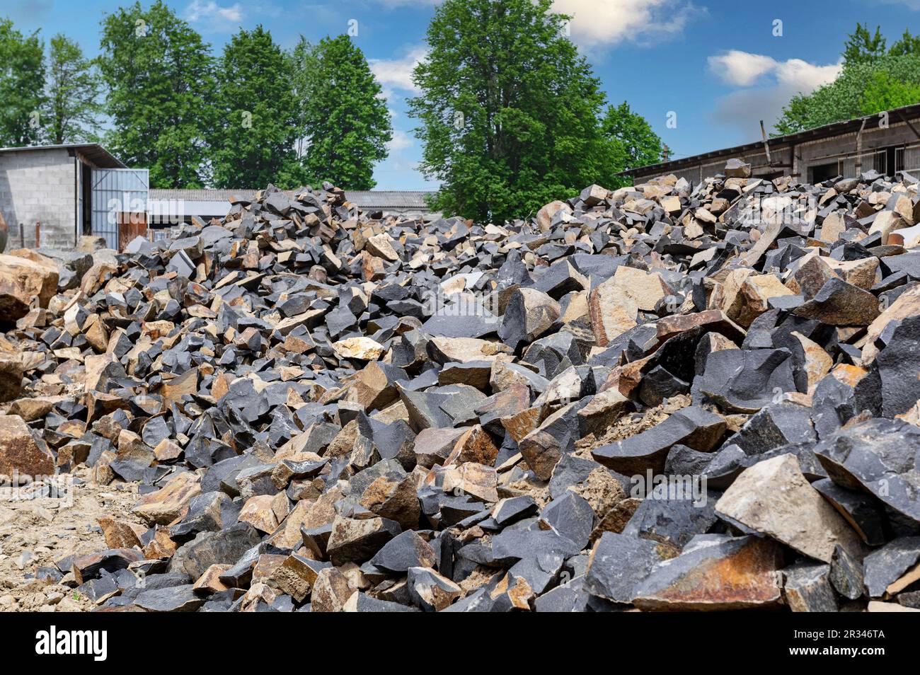Basalt stones in a quarry. Columnar basalt quarry in summer. Volcanic ...
