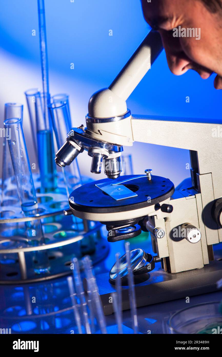 Doctor doing research using microscope hi-res stock photography and ...
