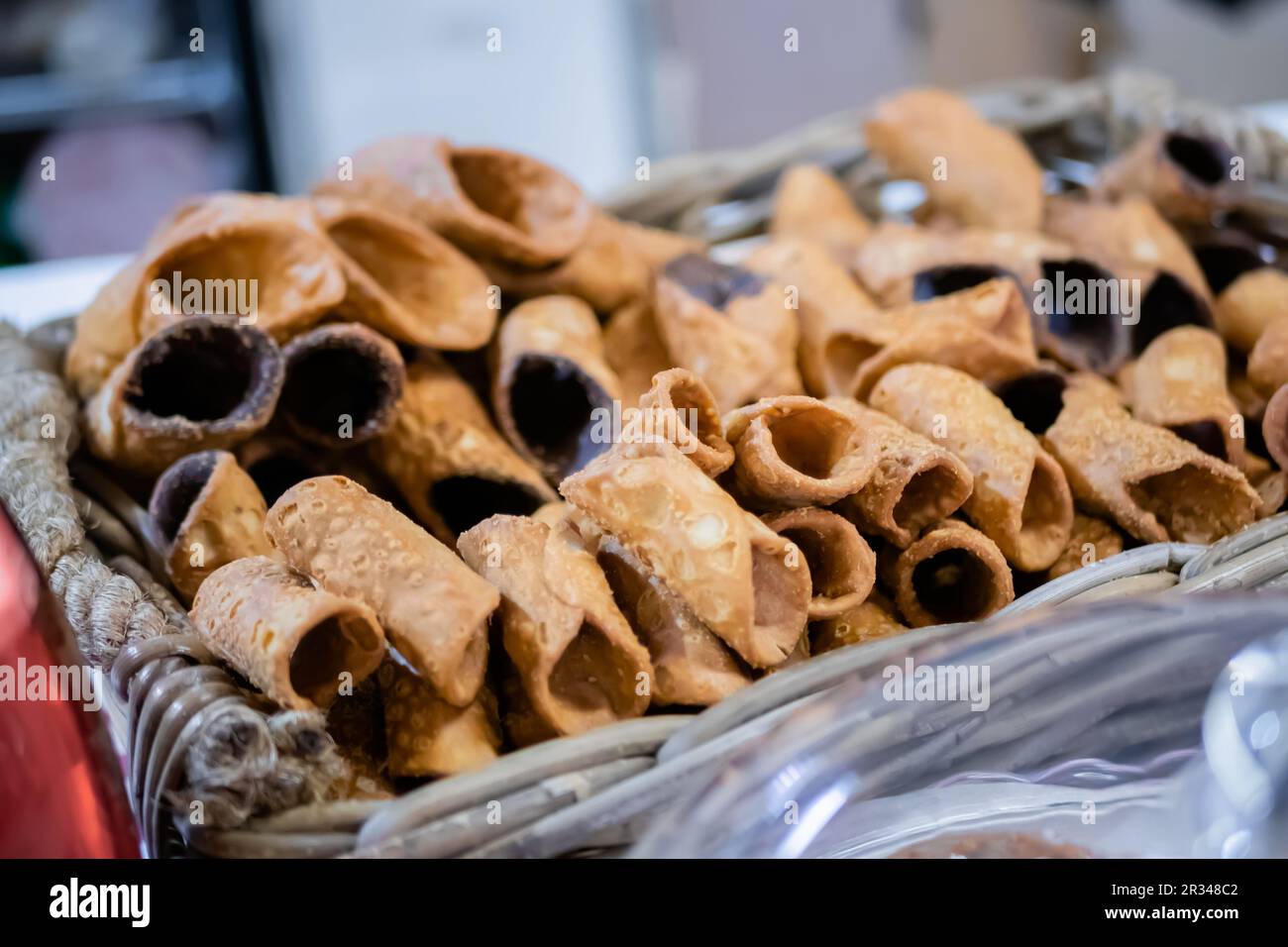 Sweet empty fried cannoli in basket on counter at food market Stock ...