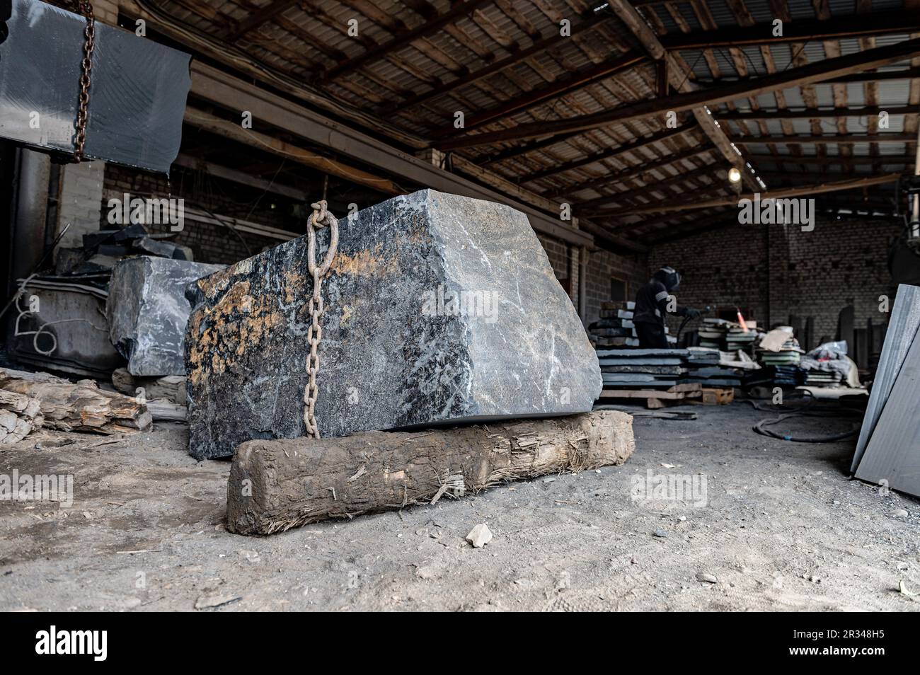 Huge granite stone in a stone processing factory. Stone cutting Stock ...