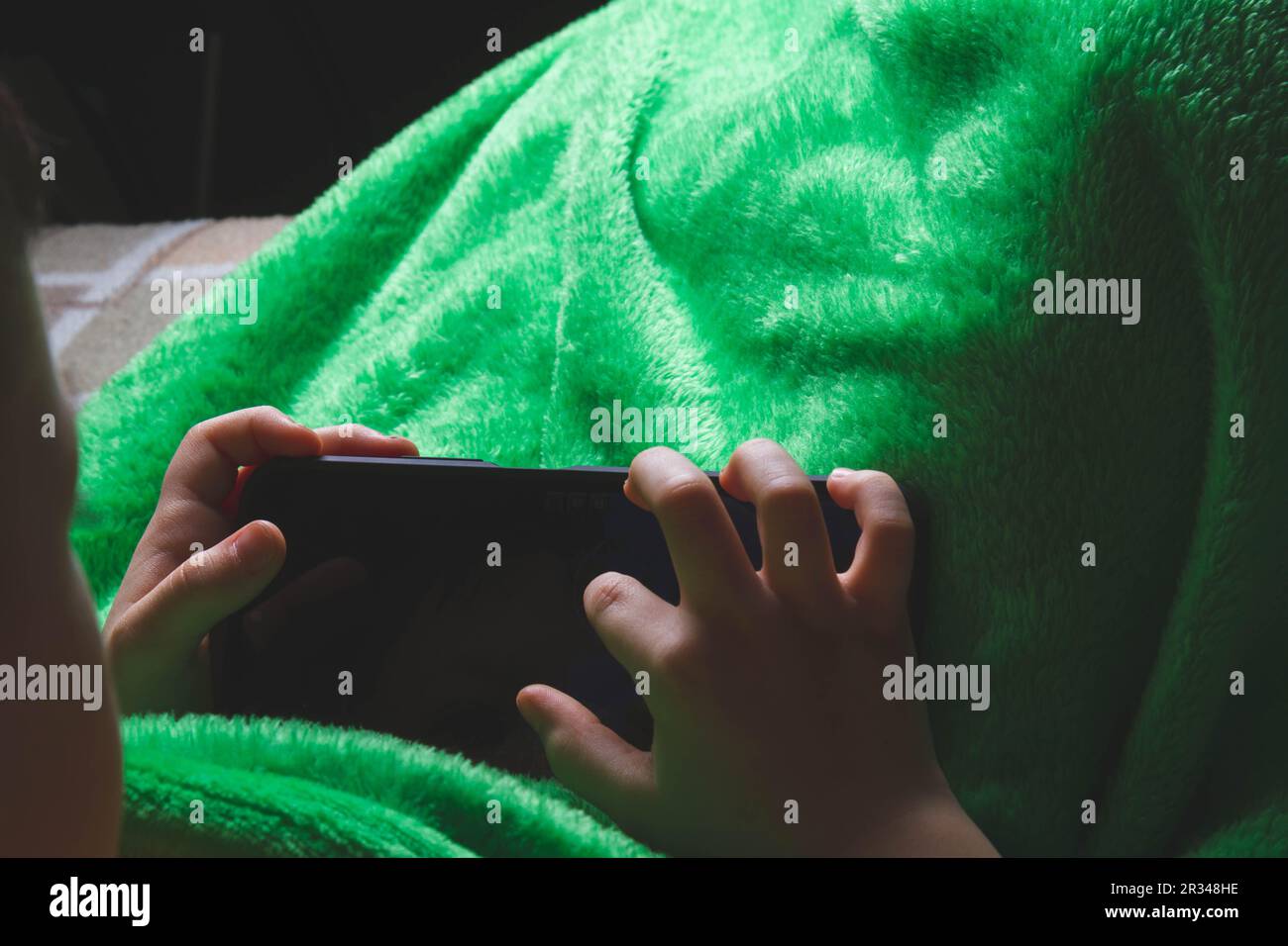 Phone in hands of child. Little boy playing mobile games on smartphone ...