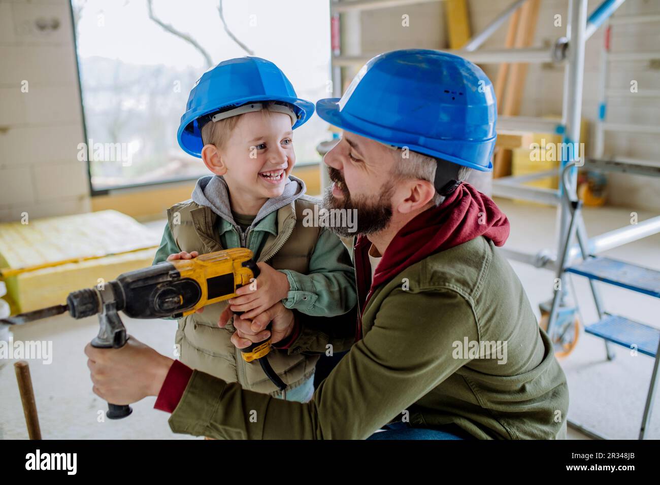 Father and his little son working on their unfinished house Stock Photo ...