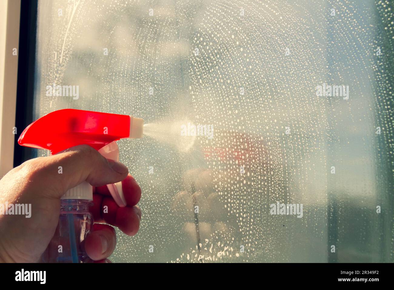 Window washing. Cleaning the window with a brush and foam. The concept ...