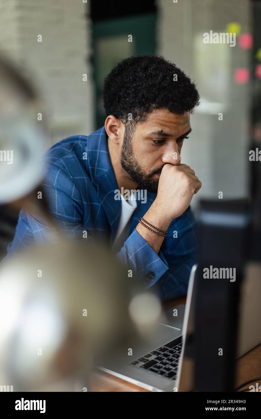 Young frustrated man sitting in front of computer in his office Stock ...