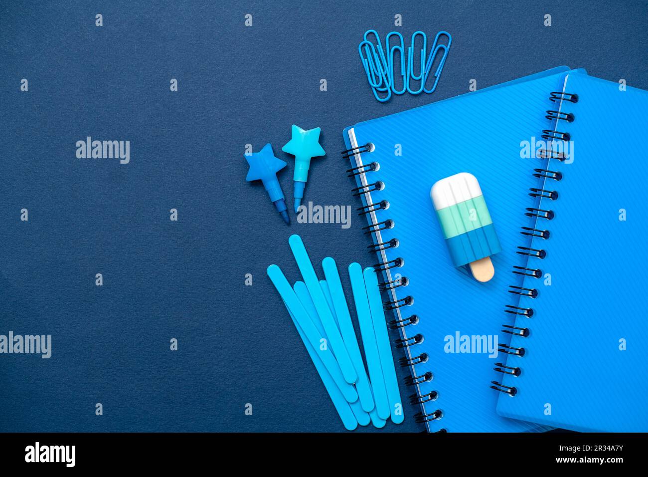 Stylish creative blue stationery and school supplies on a blue ...