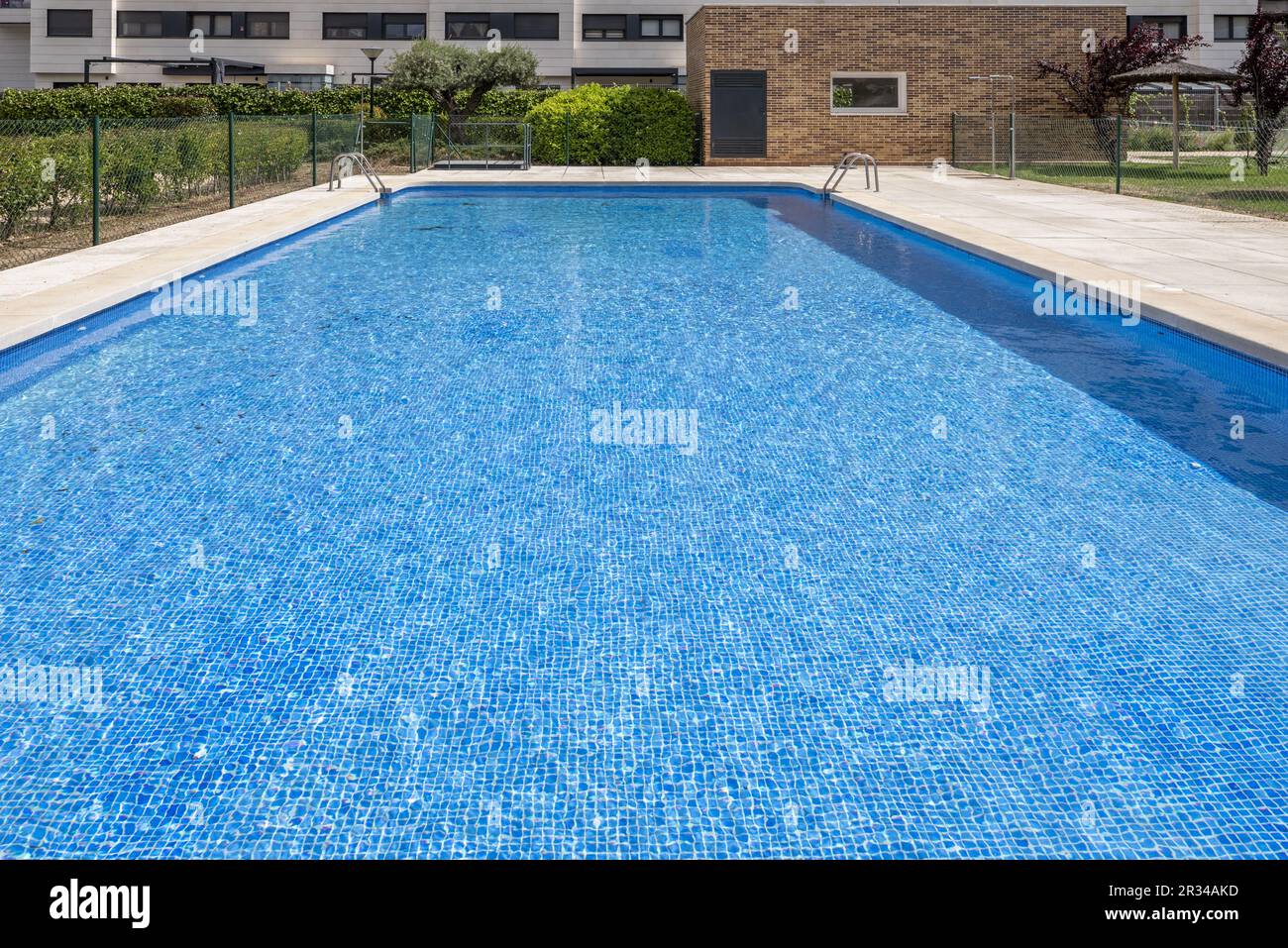 A swimming pool in an urban housing development with the type of blue ...