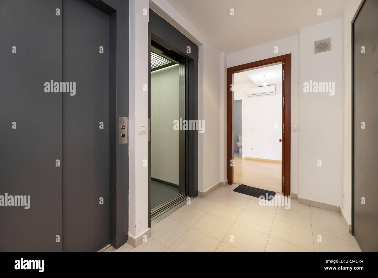 Double elevators on a landing of a residential apartment building with ...