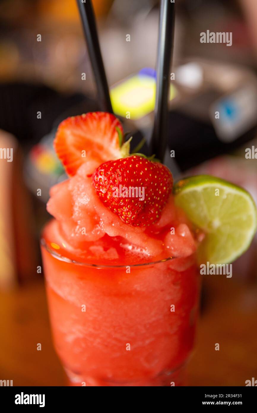Tropical Strawberry Daiquiri at a Tiki bar Stock Photo - Alamy