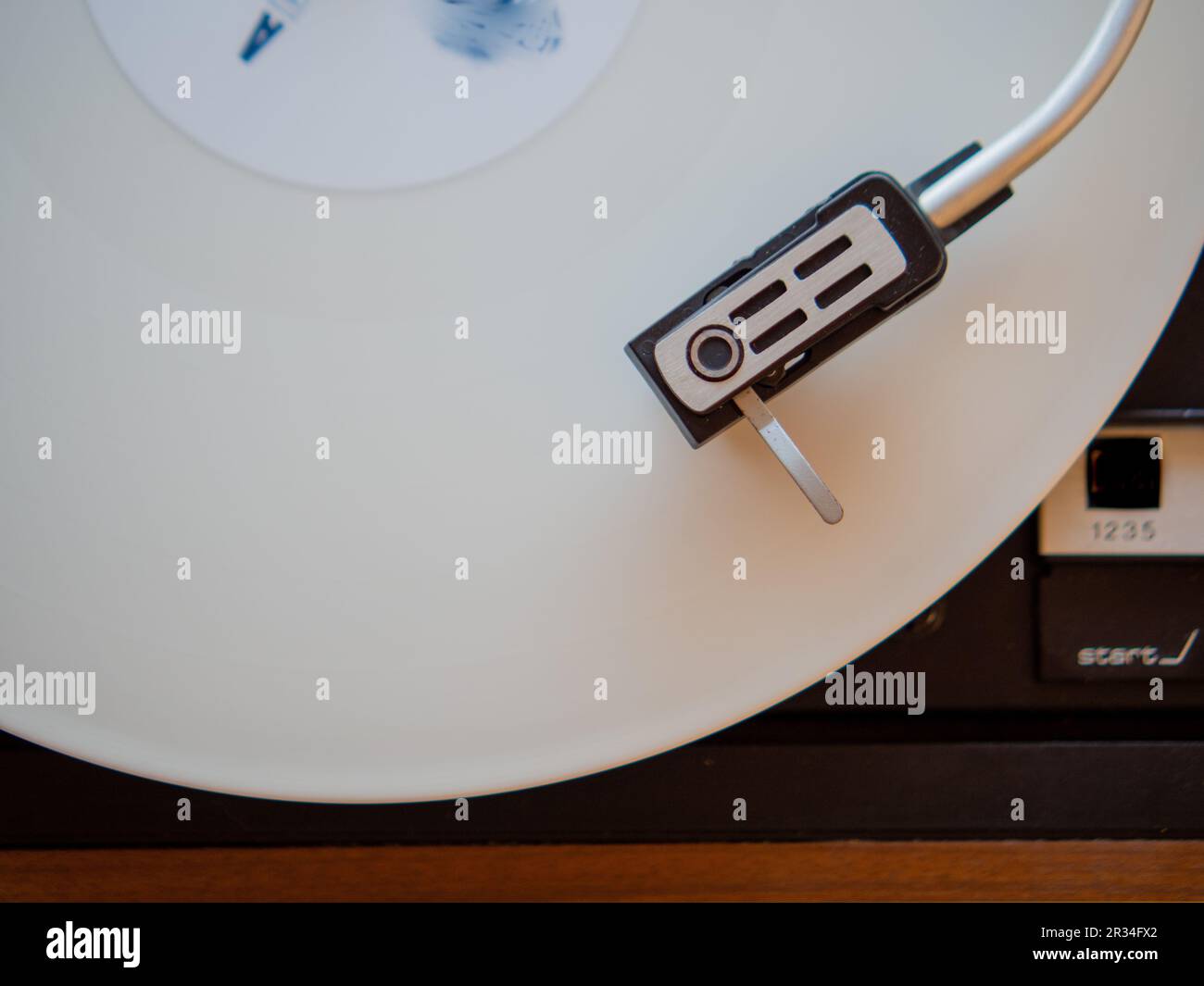 Detail of a needle on a track of a white vinyl record. Vintage ...