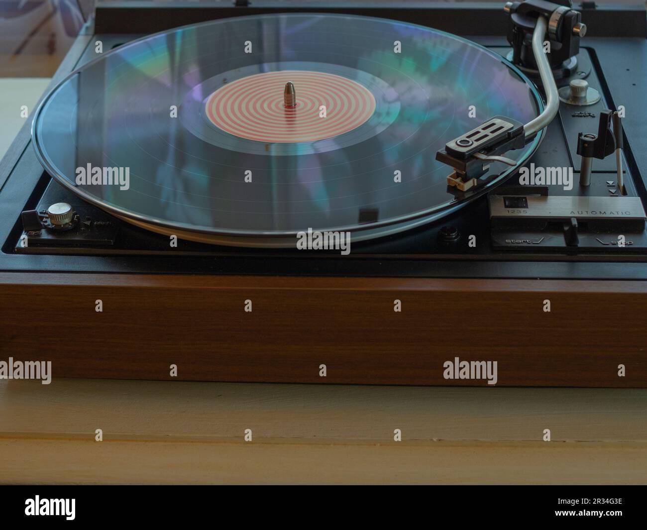Detail of a needle on a track of a black vinyl record. Vintage ...