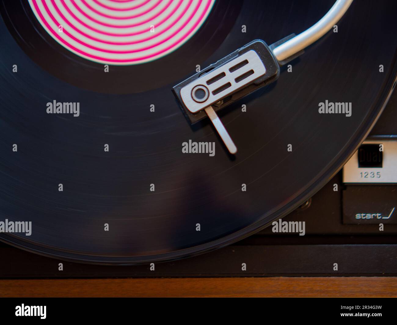 Detail of a needle on a track of a black vinyl record. Vintage ...