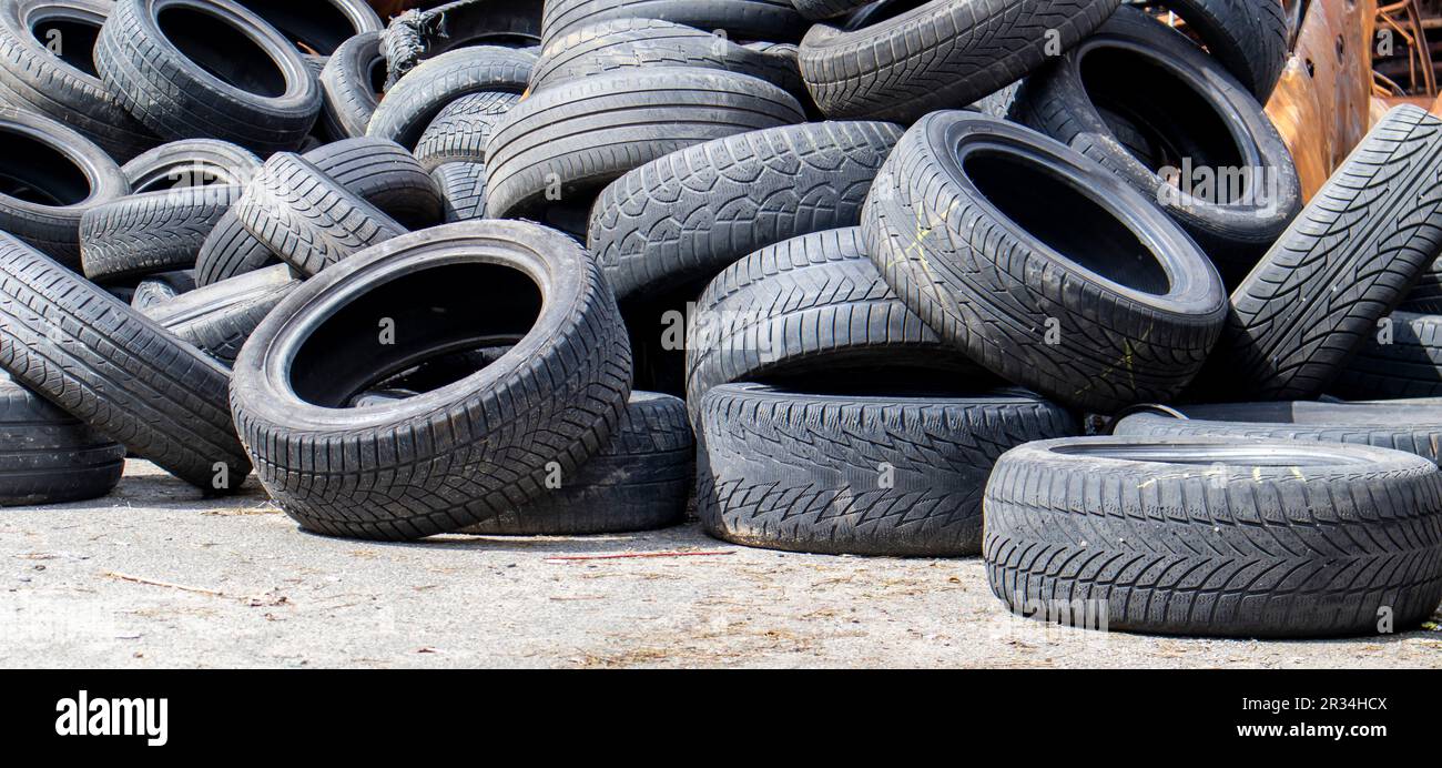 Industrial dump for the processing of used tires and rubber tires. Pile ...
