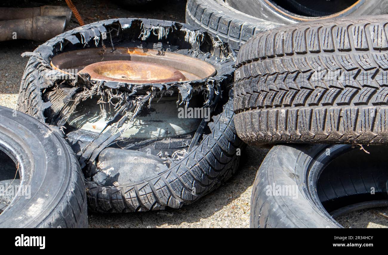 Industrial dump for the processing of used tires and rubber tires. Pile ...