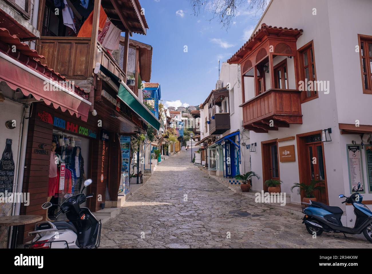 Beautiful street in the Kas old town with boutique shops at sunset ...