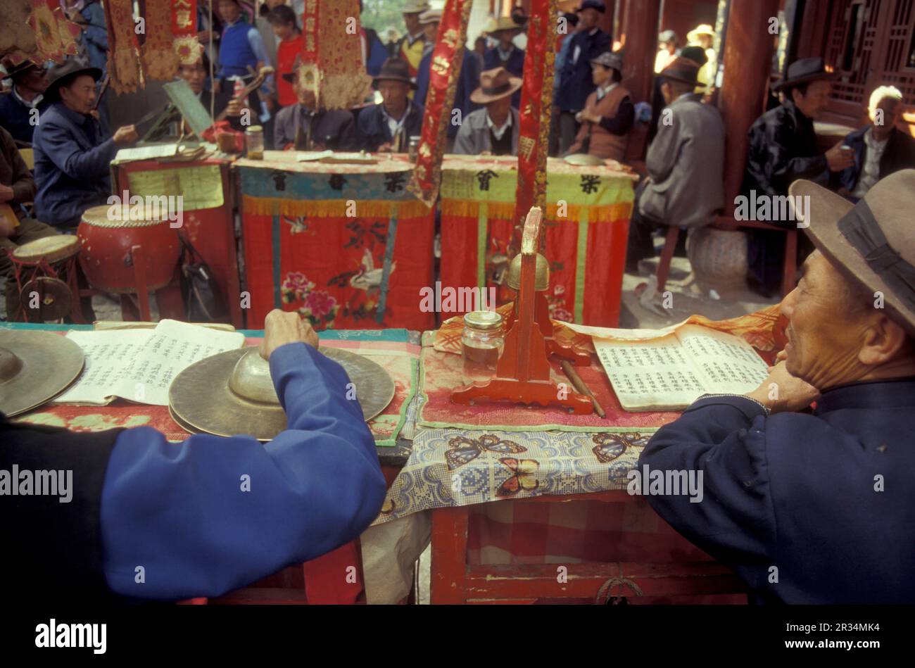 chinese Minority People at a ceremony in a old Temple in traditional ...