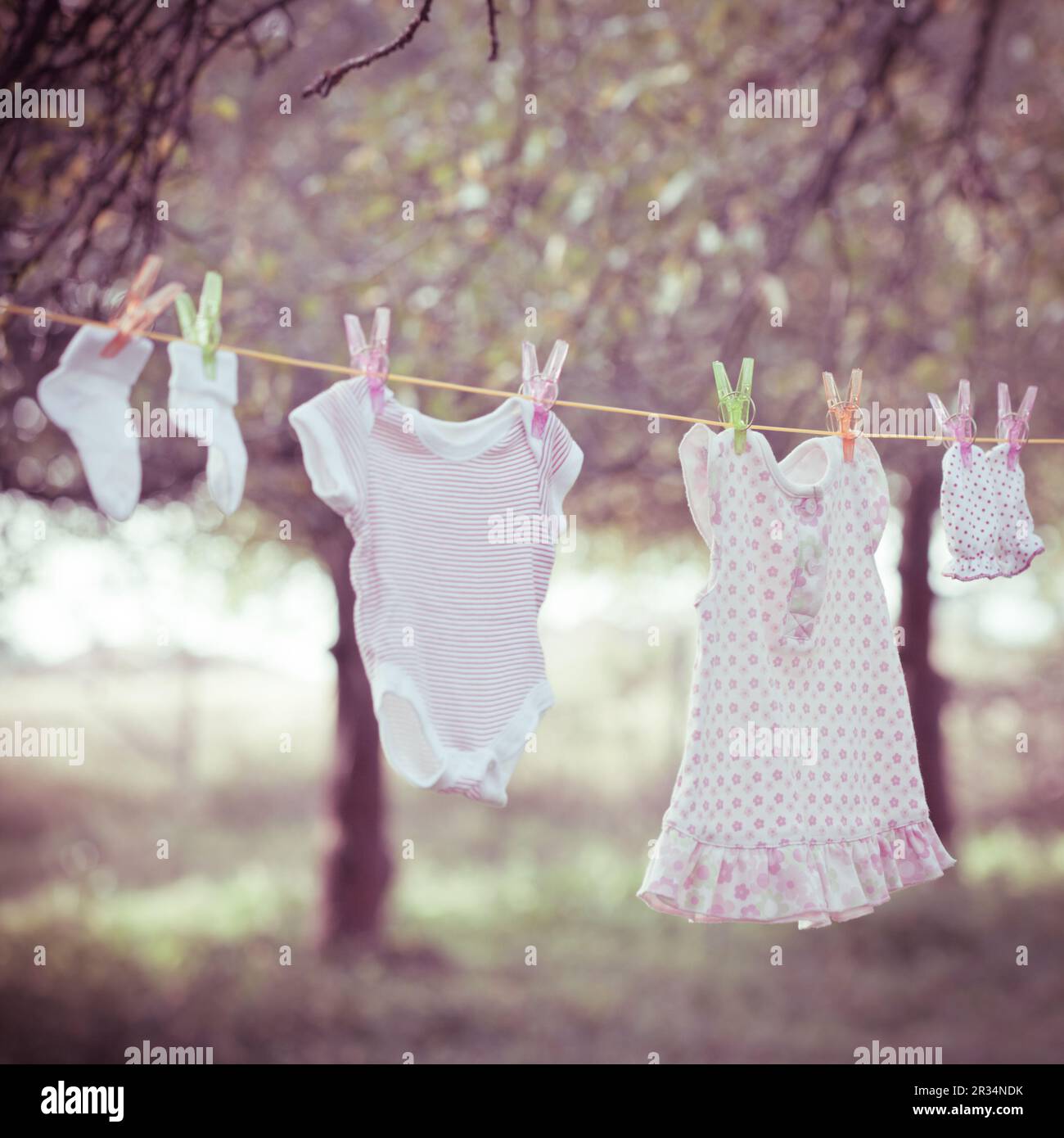 Washing line with baby clothing hi-res stock photography and images - Alamy