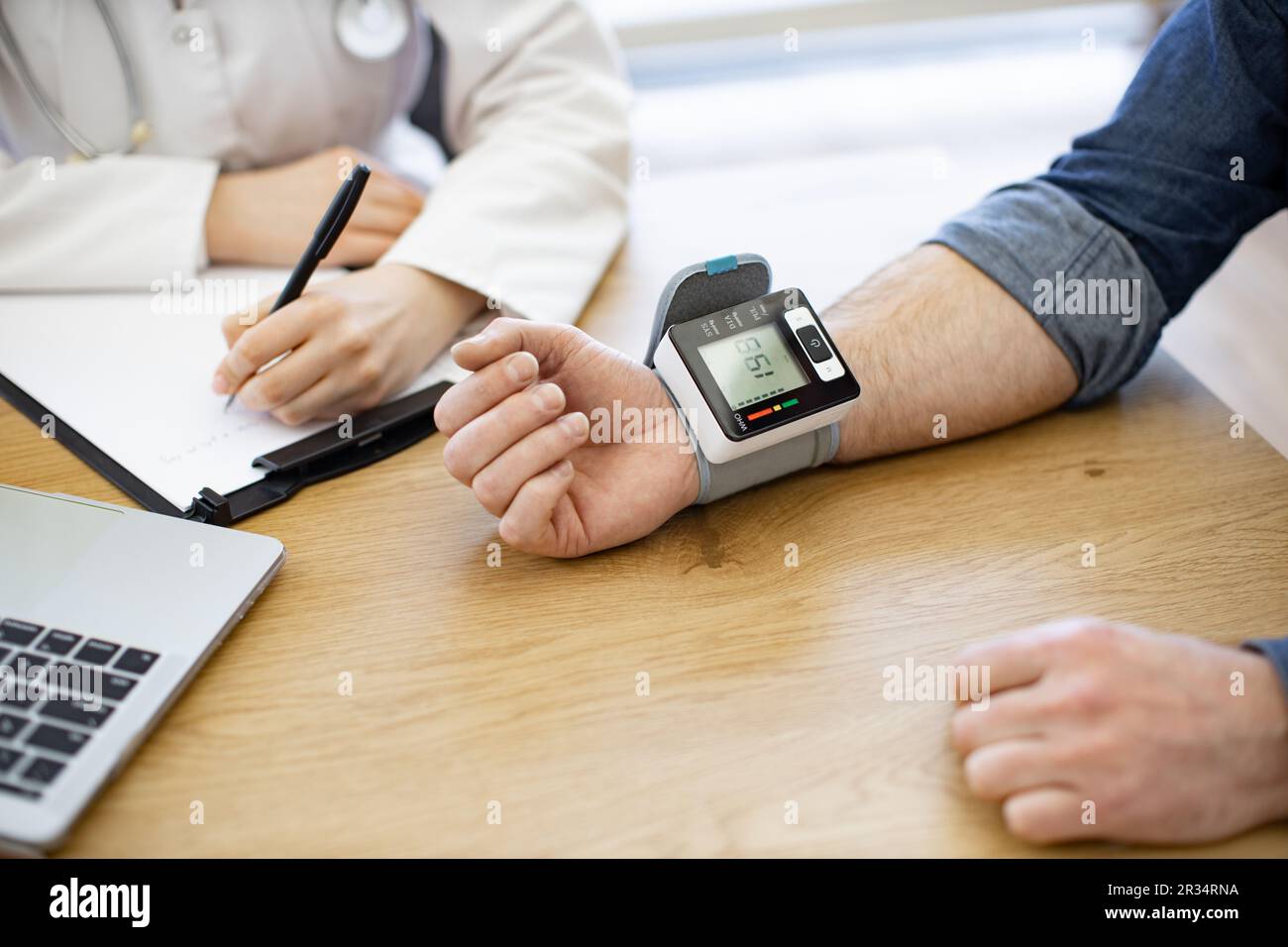 Crop of male patient measuring blood pressure with modern electronic ...