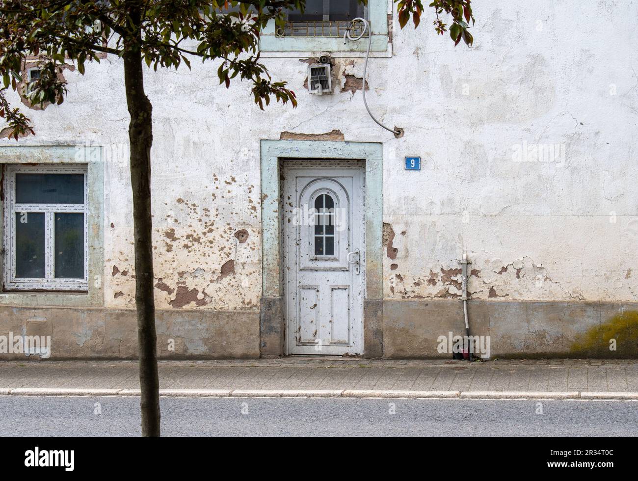 old lost house with a weathered white door Stock Photo - Alamy