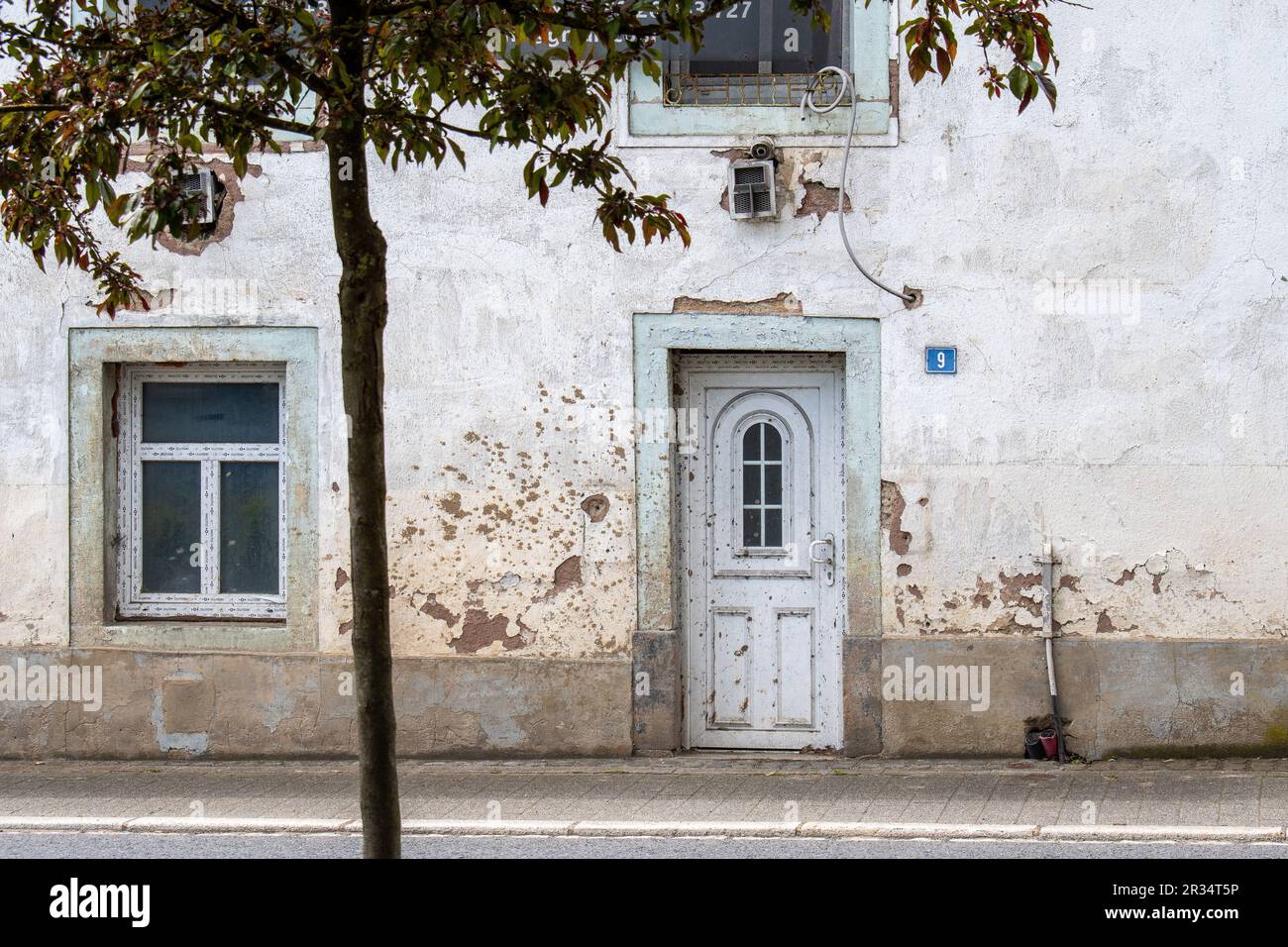 old lost house with a weathered white door Stock Photo - Alamy