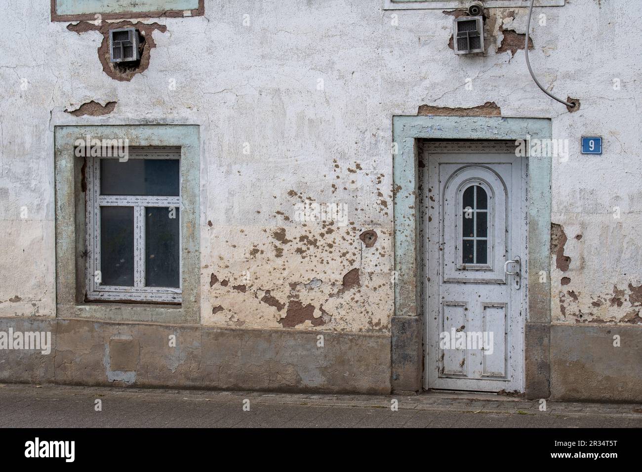 old lost house with a weathered white door Stock Photo - Alamy