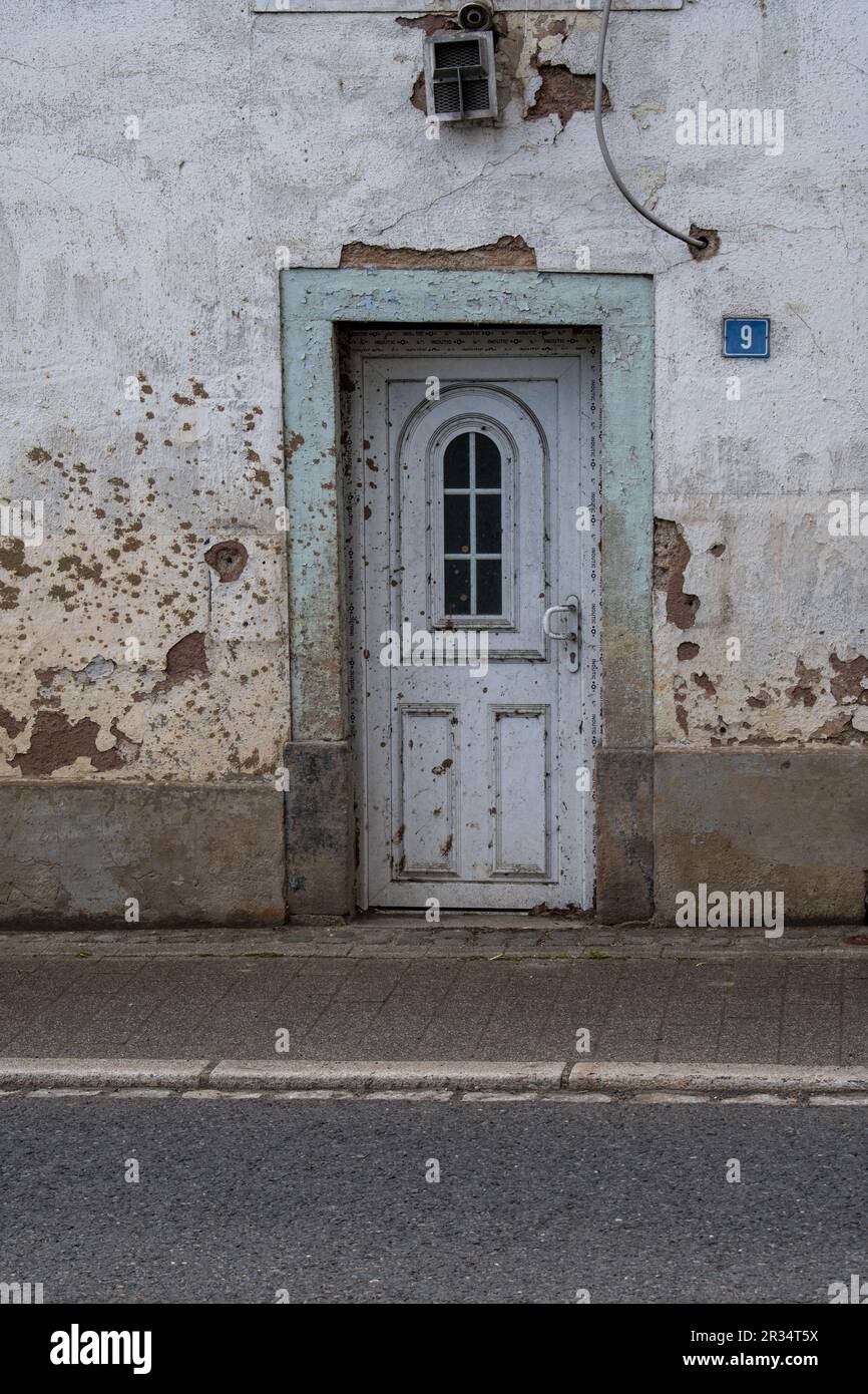 old lost house with a weathered white door Stock Photo - Alamy