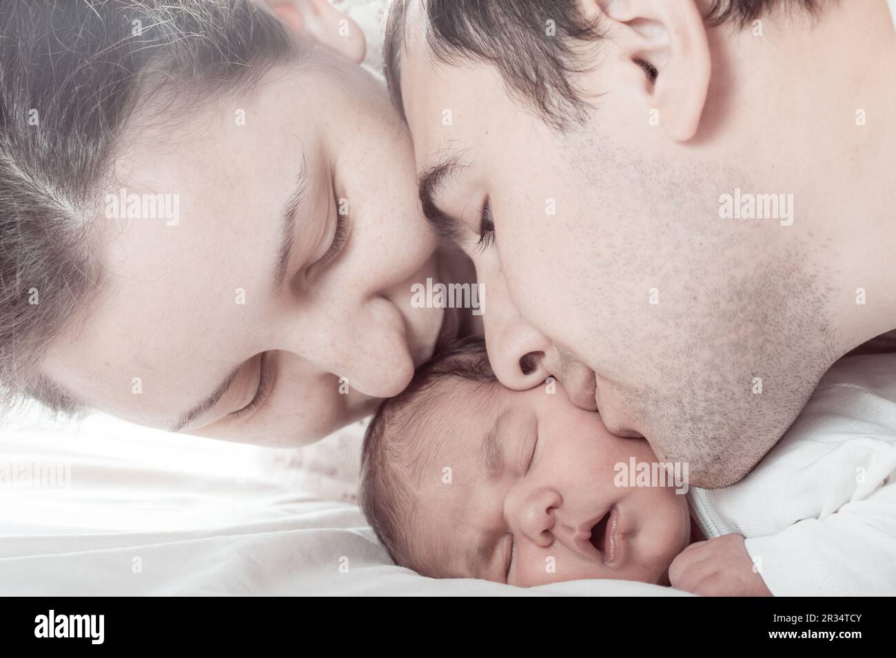 Baby with mom and dad Stock Photo - Alamy