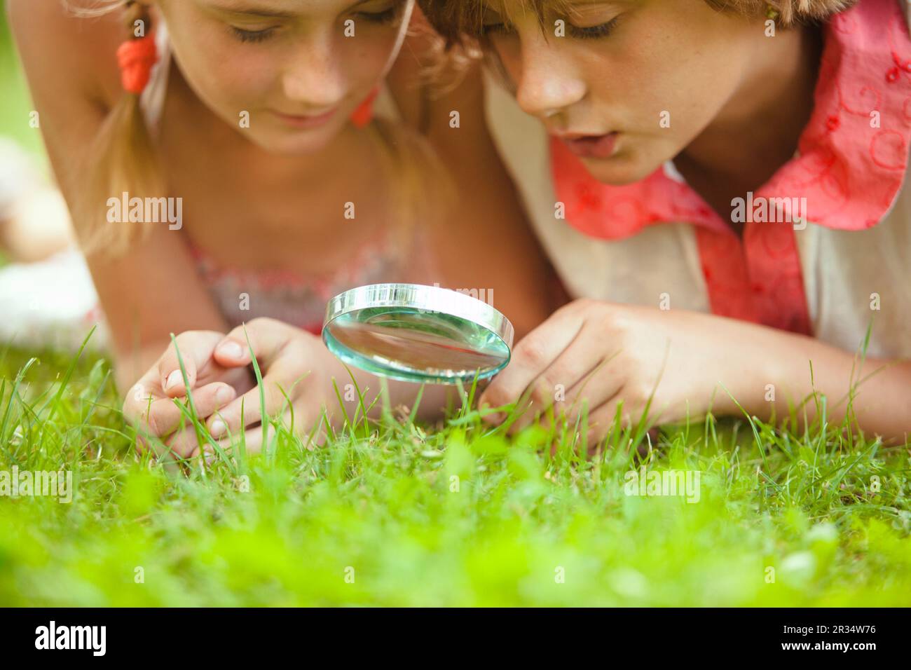 Kid with magnifying glass Stock Photo - Alamy